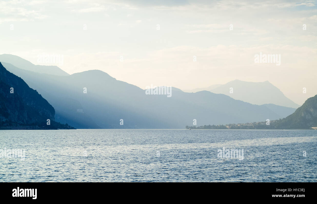 mountains near Lake Como in Italy disappearing in evening sunlight ...