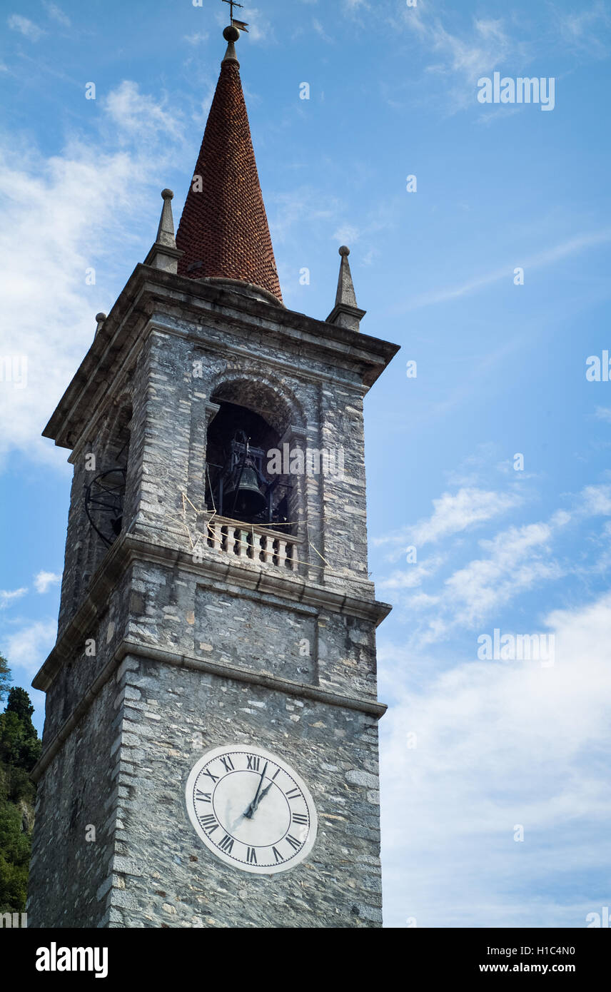 an old stone bell tower photographed against blue sky in Varenna, Italy ...