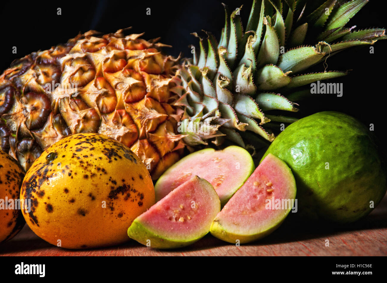 Assortment of cuban fruits, mango, guava and pinneaple against black ...