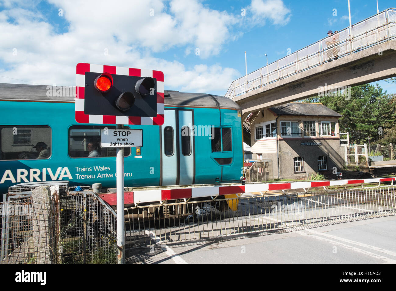 Arriva train passing barrier of a level crossing at Ferryside village ...