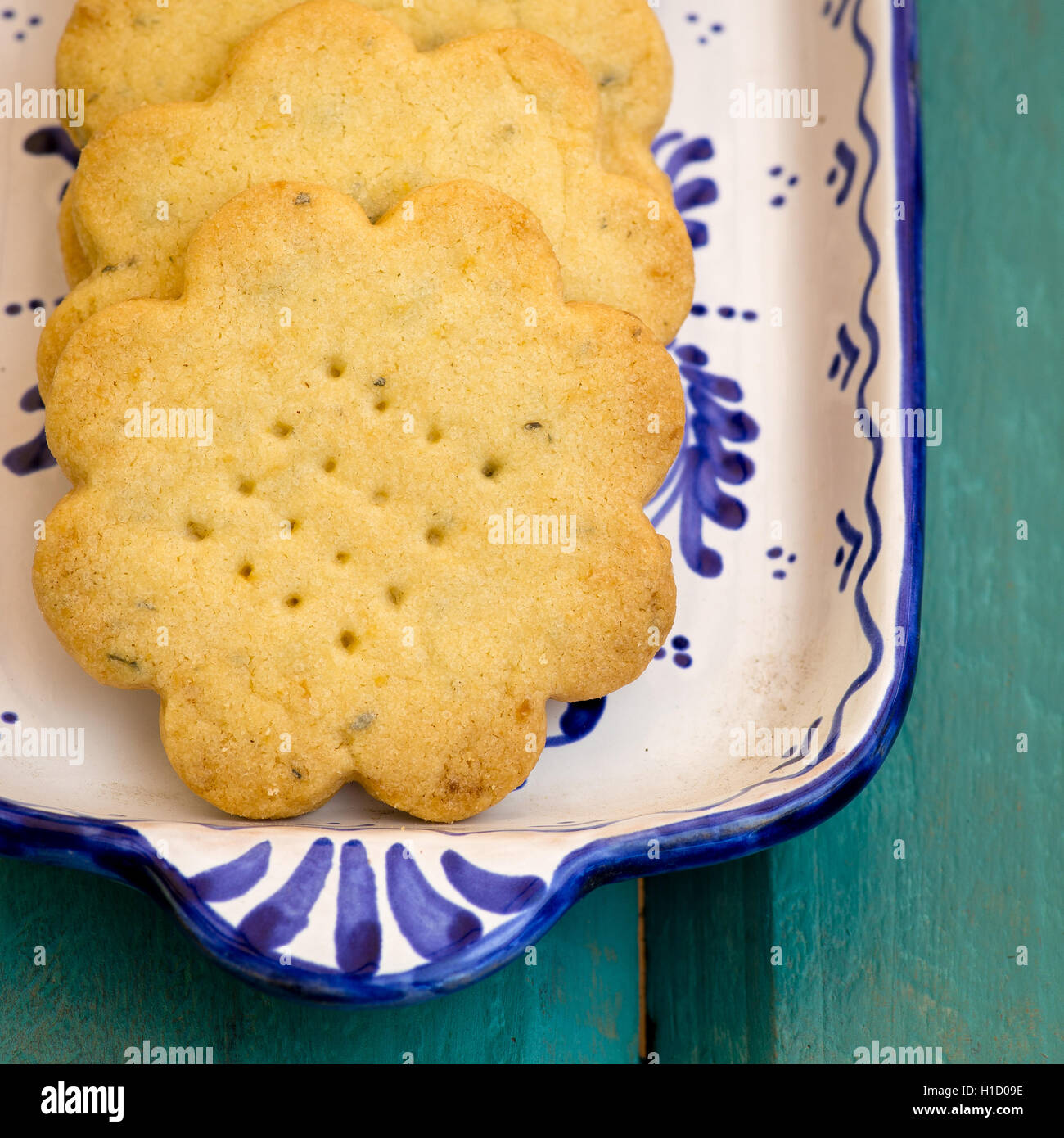 Lemon thyme flower shaped shortbread cookies on blue and white vintage ...
