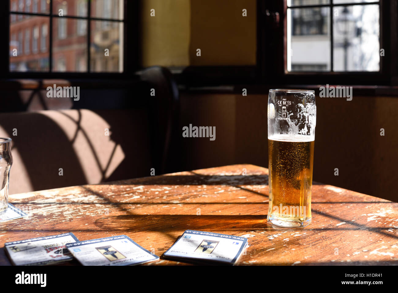 Half Full Glass Of Lager Stock Photo - Alamy