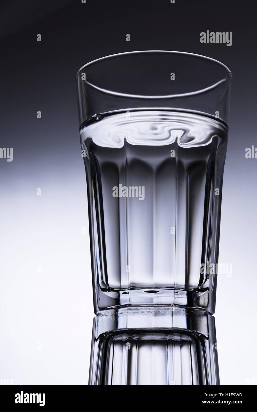 simple water-glass with light surface Stock Photo - Alamy
