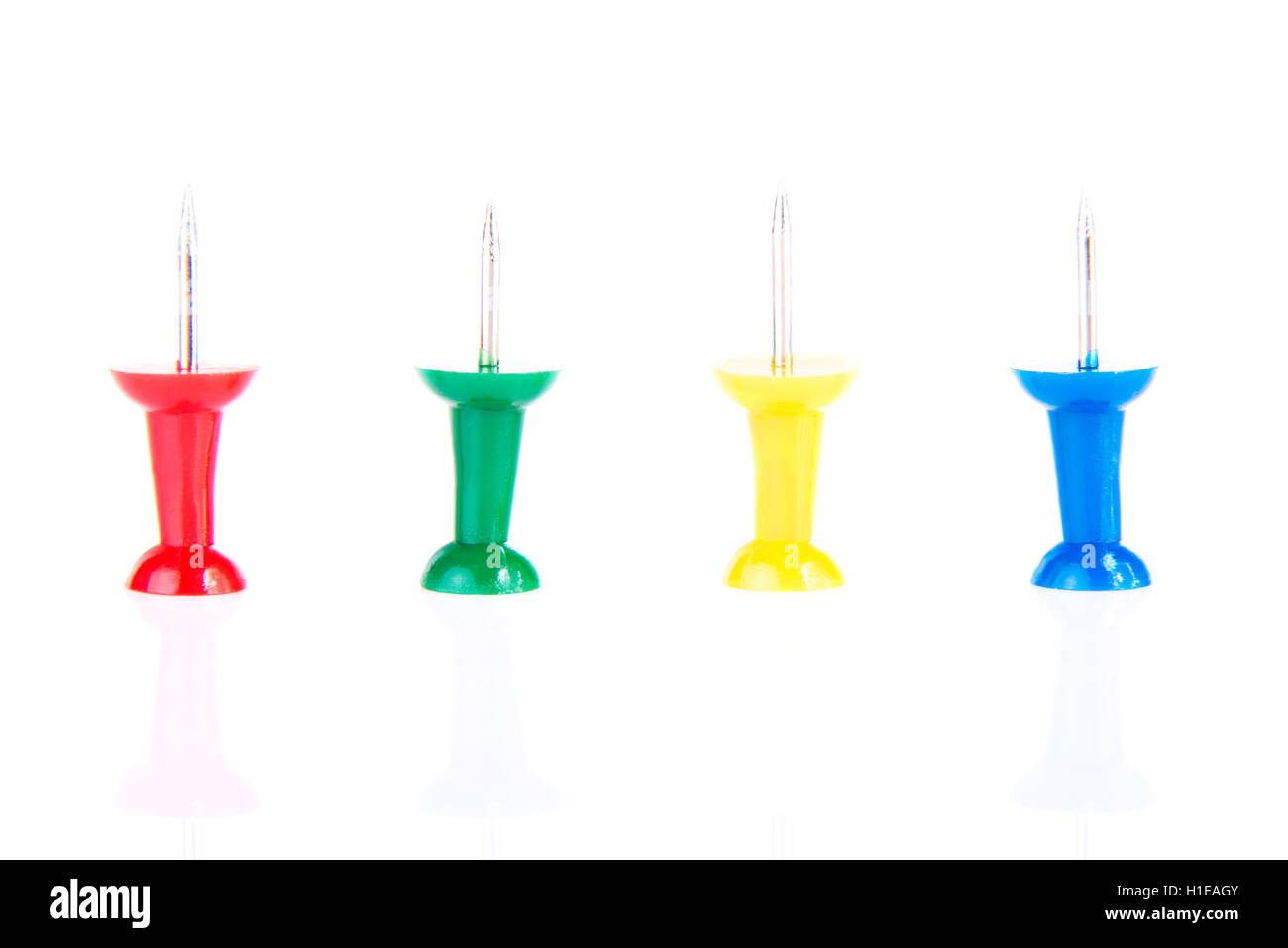 Four colorful drawing pins Stock Photo - Alamy