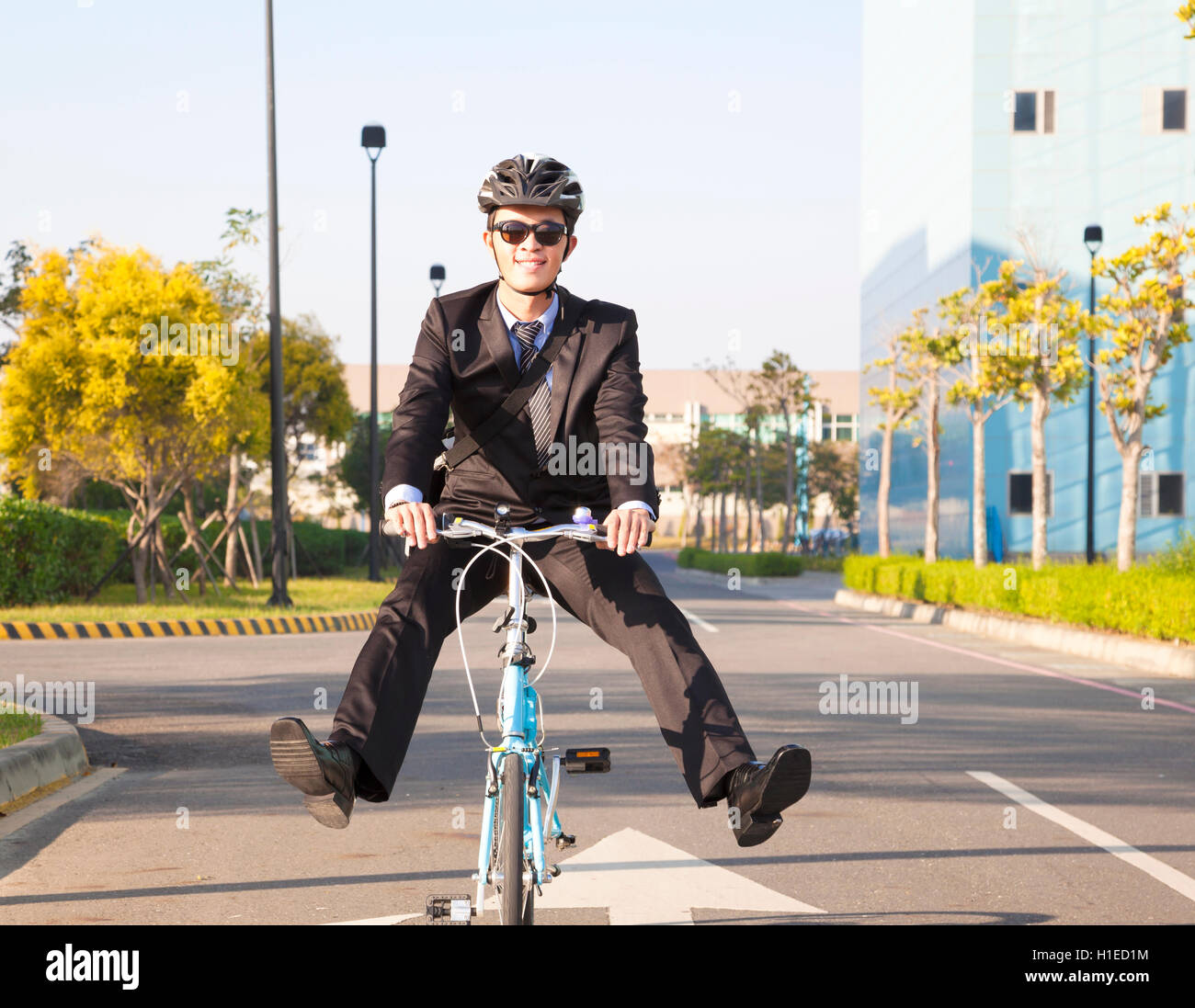 businessman riding bicycle to office for eco-friendly Stock Photo - Alamy