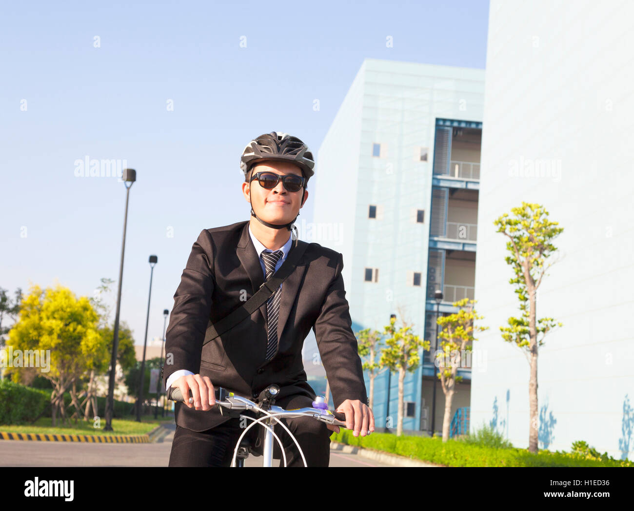 businessman riding a bicycle to workplace for protecting environ Stock ...
