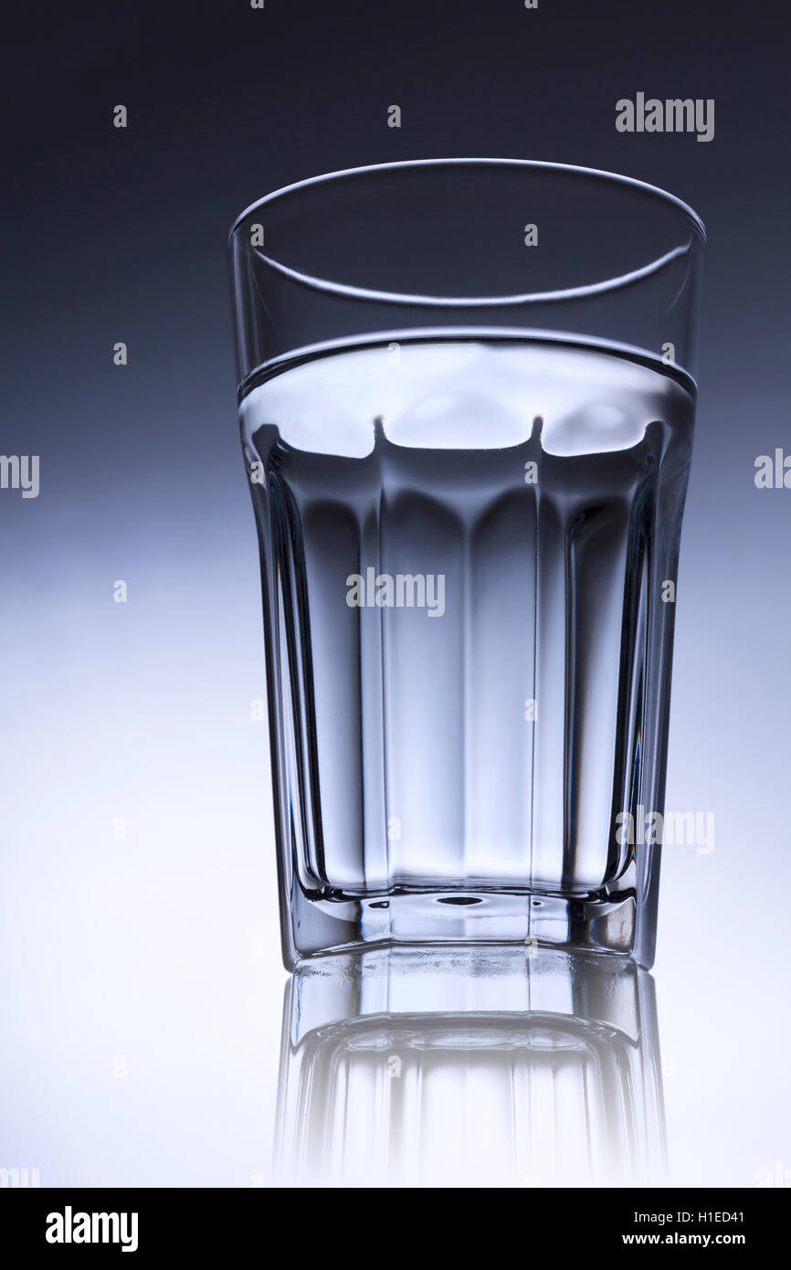 simple water-glass with light surface Stock Photo - Alamy