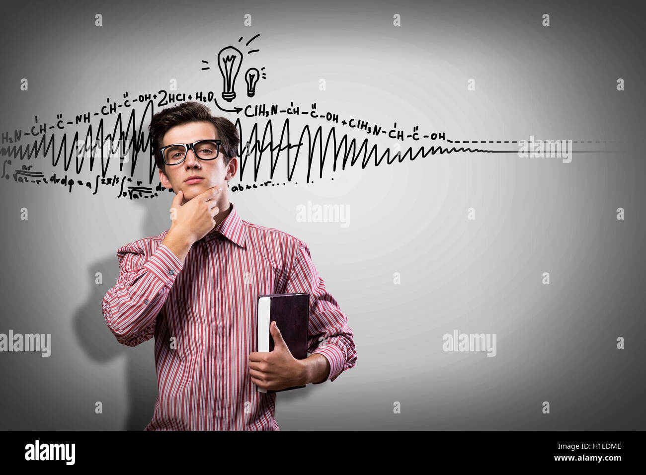 young man scientist with glasses thinking Stock Photo - Alamy