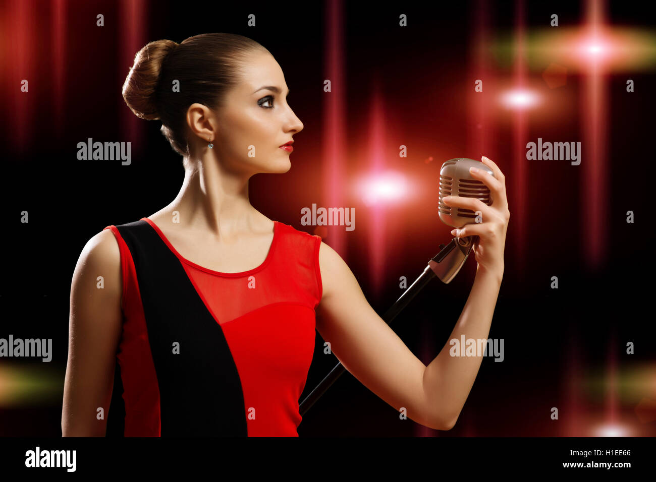 attractive female singer with microphone Stock Photo - Alamy