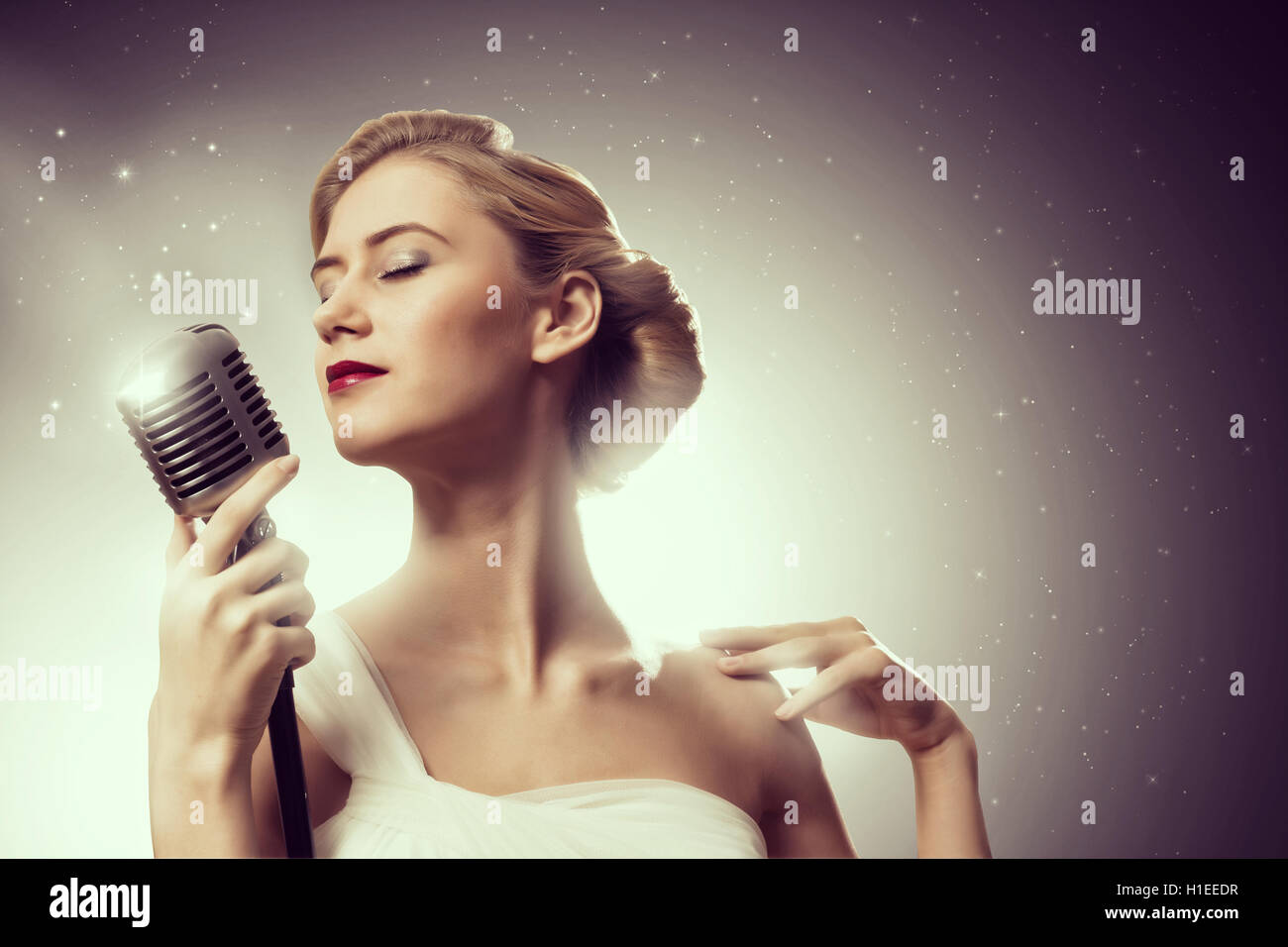 attractive female singer with microphone Stock Photo - Alamy
