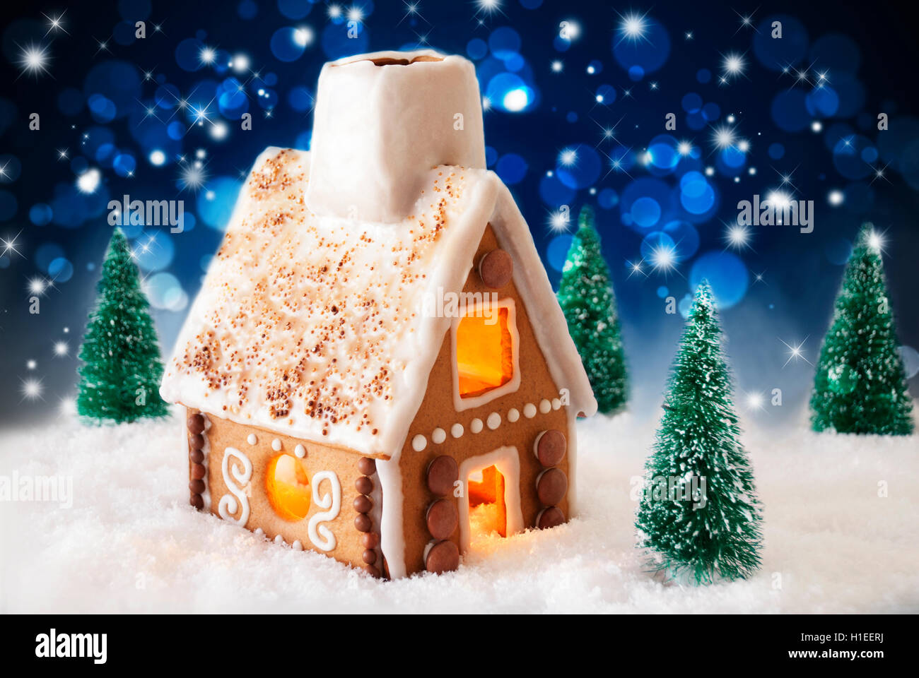 Gingerbread House On Snow And Bokeh Effect Stock Photo - Alamy