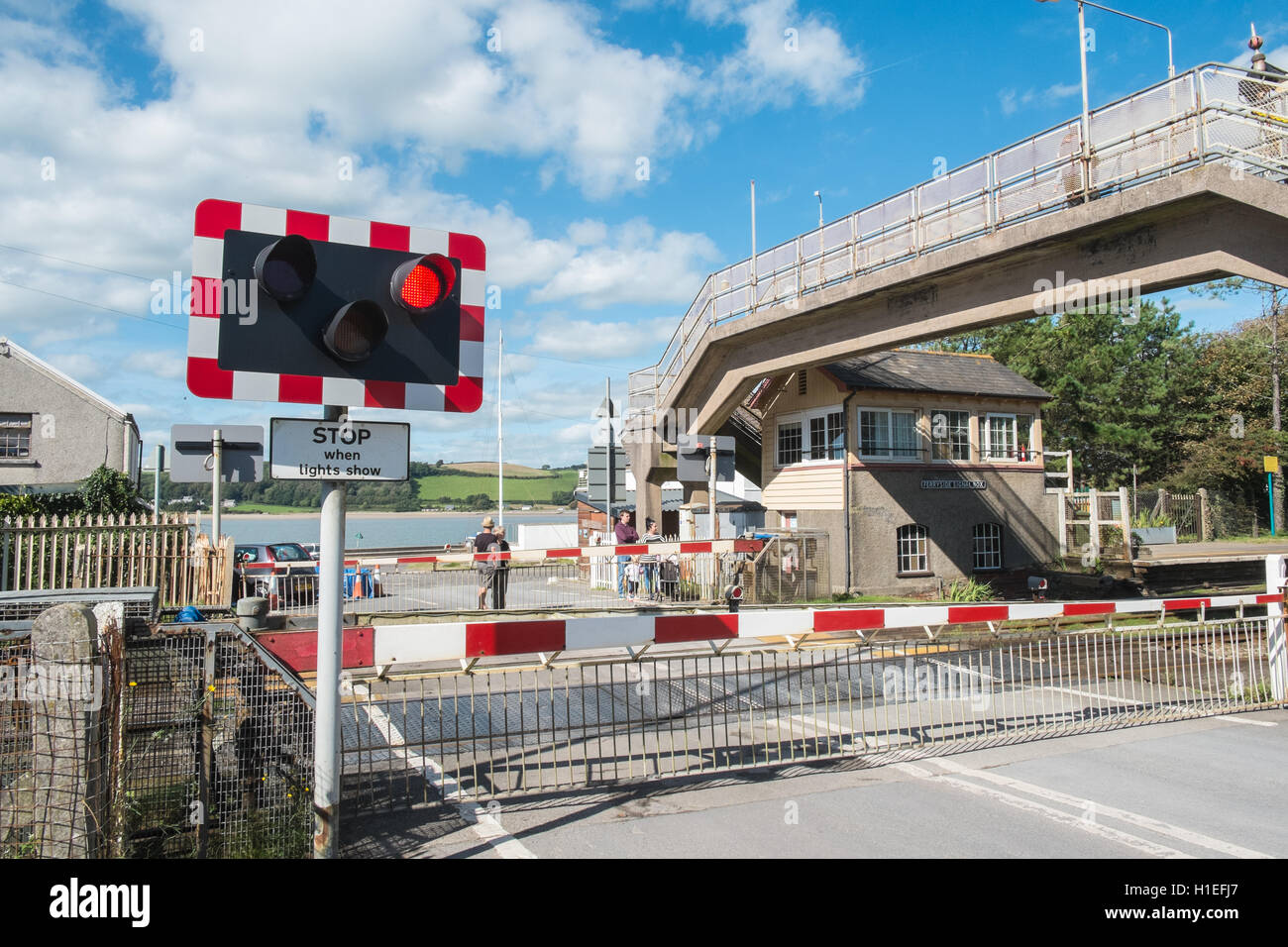 Arriva train passing barrier of a level crossing at Ferryside village ...