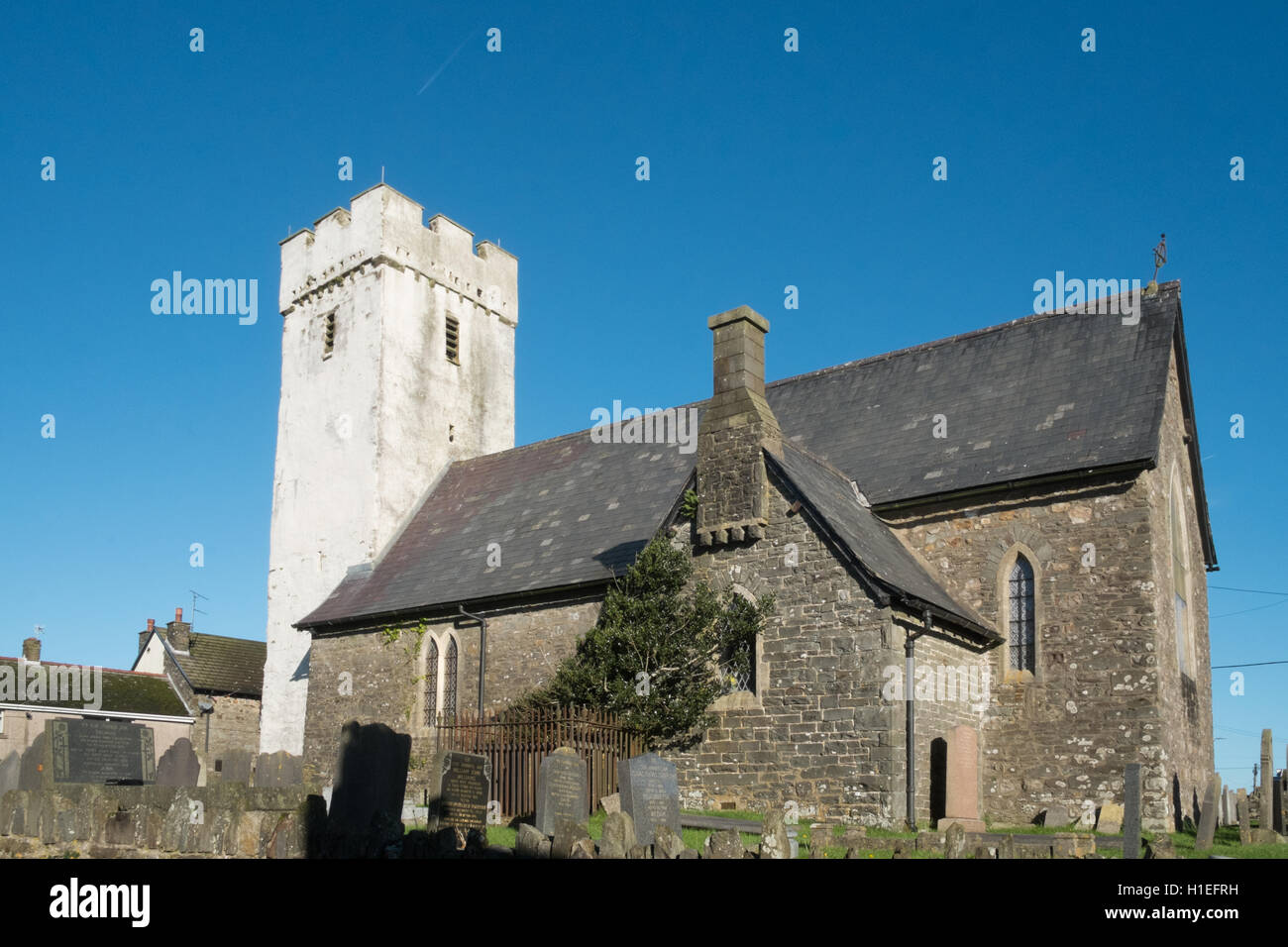 Ancient church and bell tower in centre of village of Llansaint,a ...