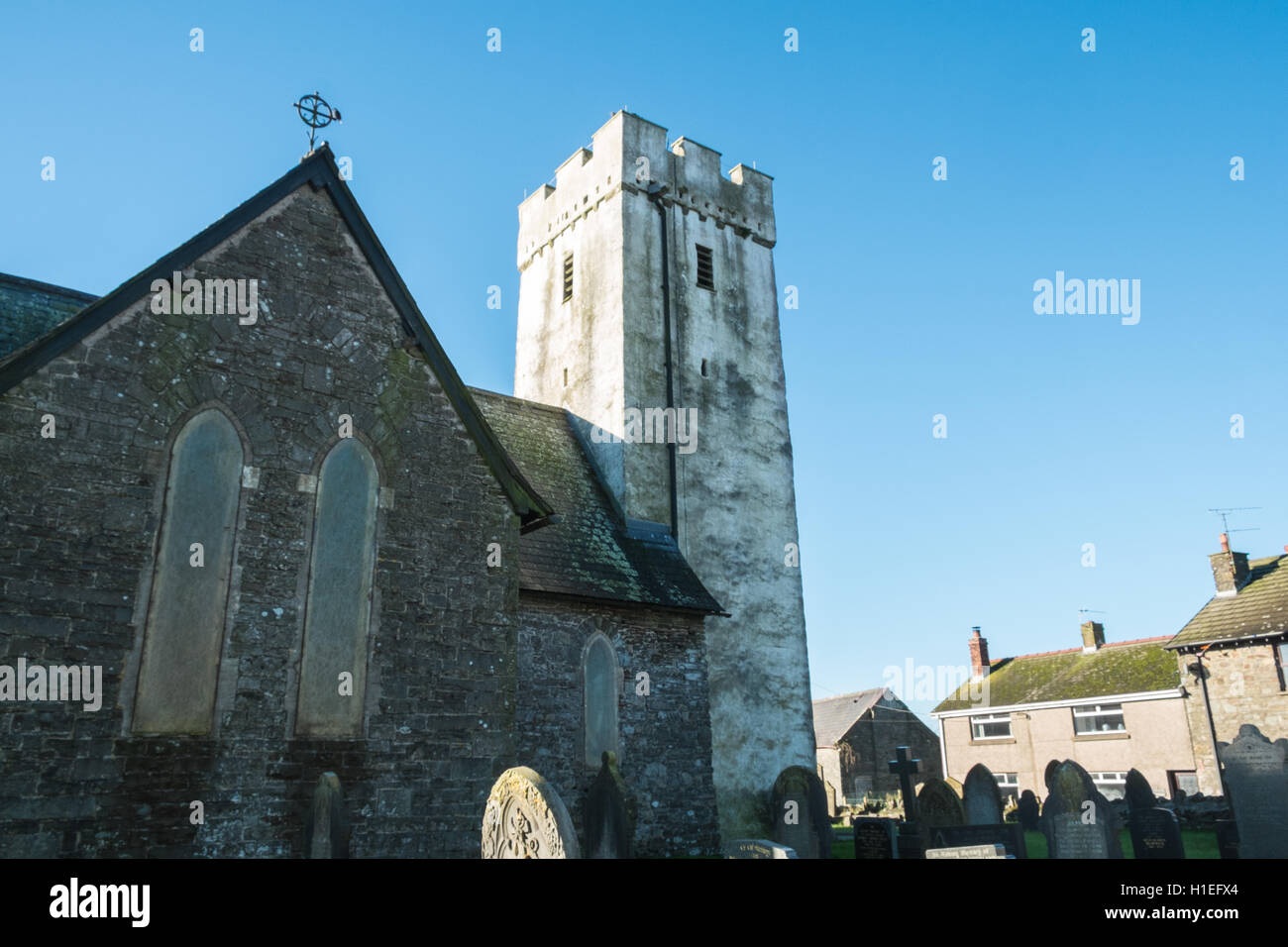 Ancient church and bell tower in centre of village of Llansaint,a ...