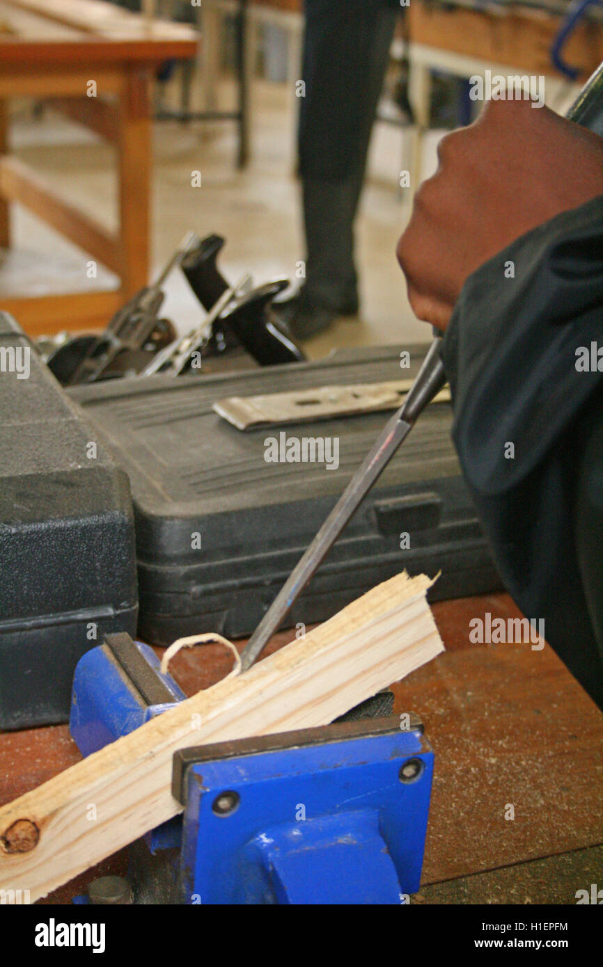 School boy chiseling with hammer in woodwork classroom, St Mark's ...