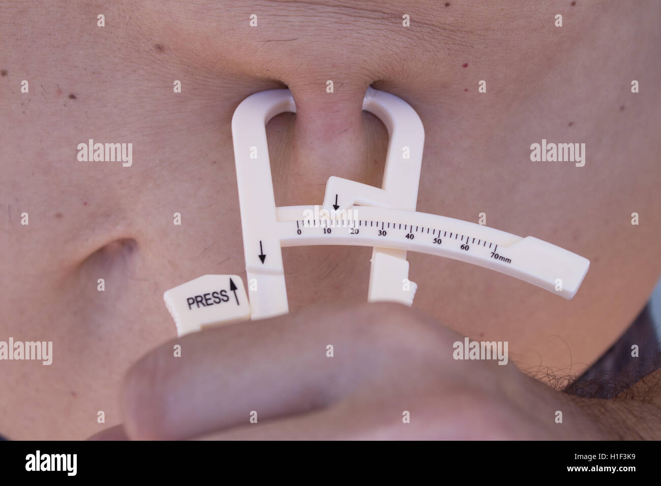 Body of a man measuring contour and body fat Stock Photo - Alamy