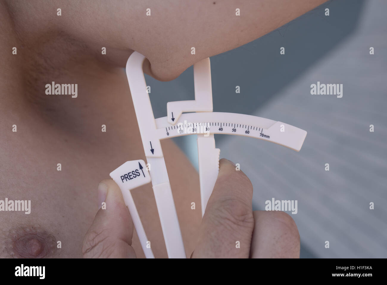 Body of a man measuring contour and body fat Stock Photo - Alamy