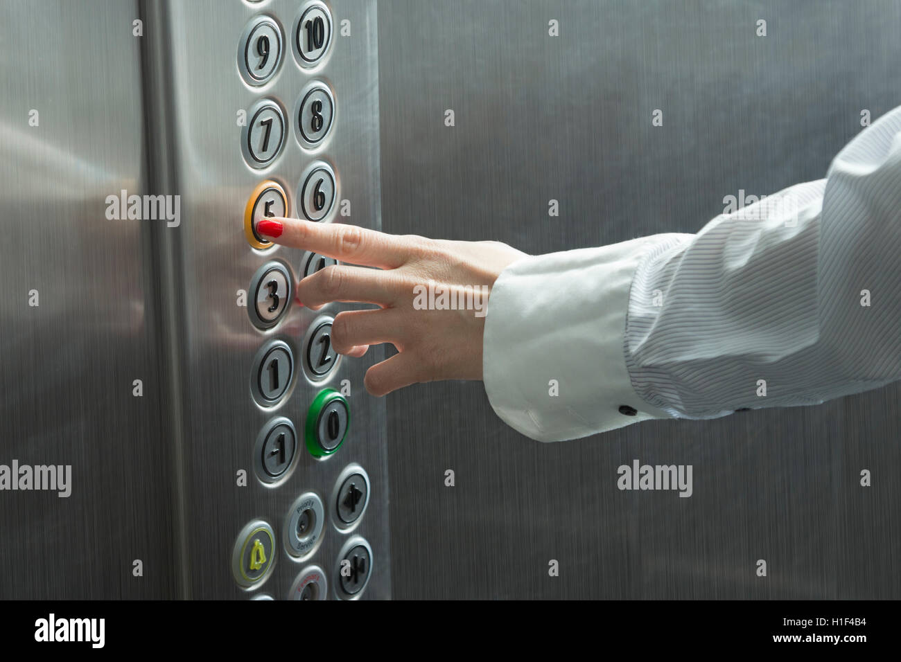 Female hand pressing the button in the elevator Stock Photo - Alamy