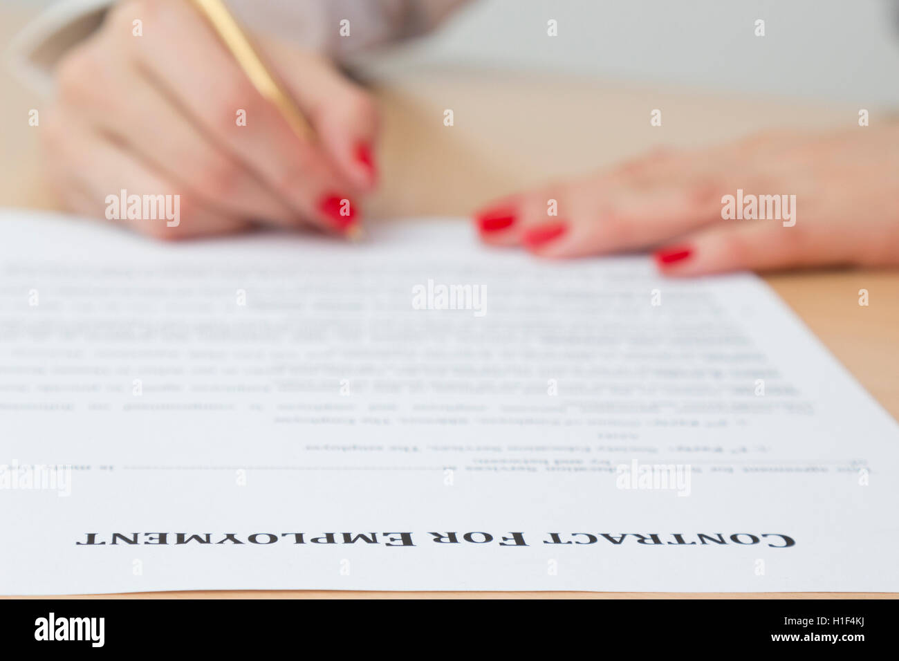 Woman signing employment contract Stock Photo - Alamy