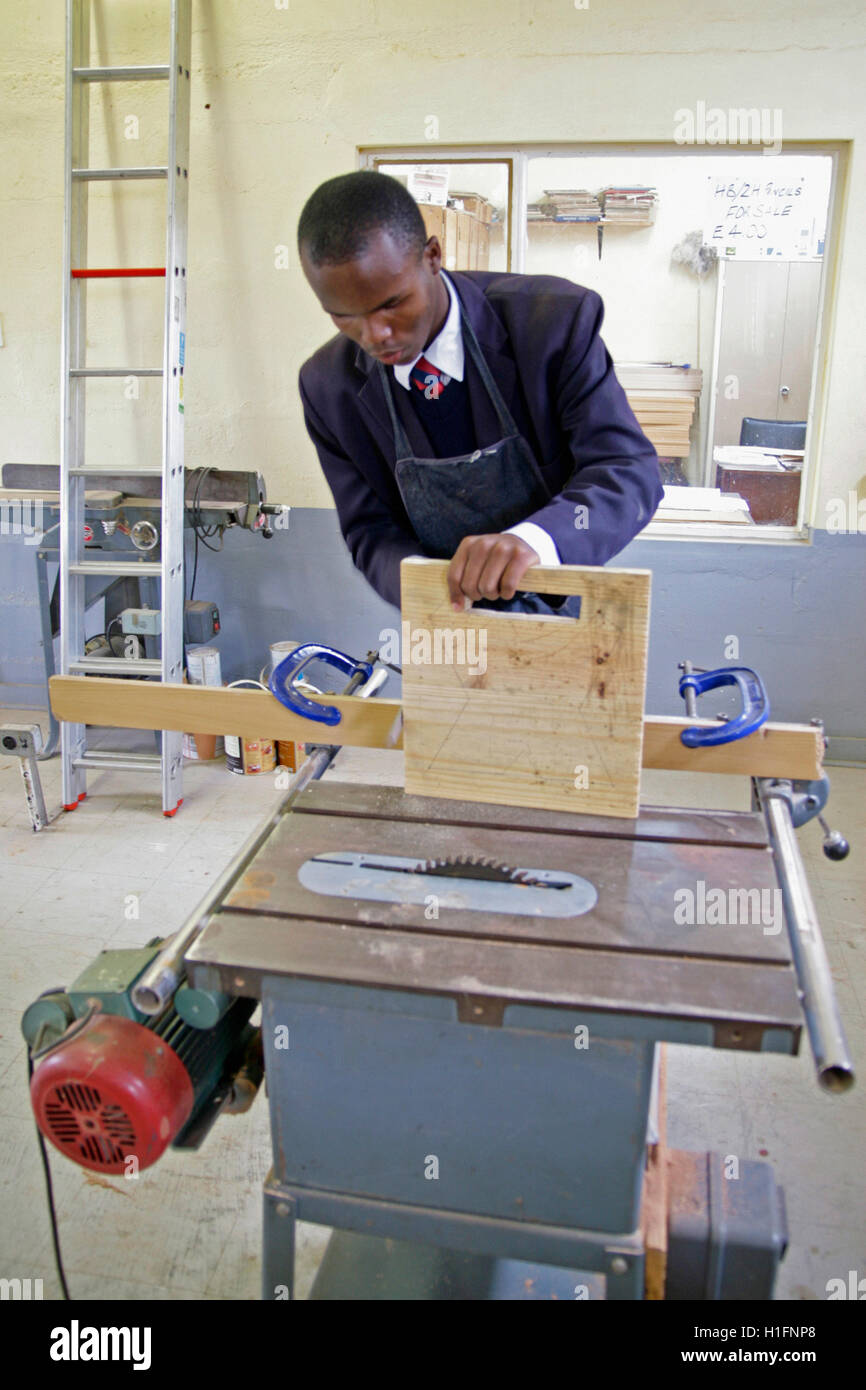 School boy using cut saw in woodwork classroom, St Mark's School ...