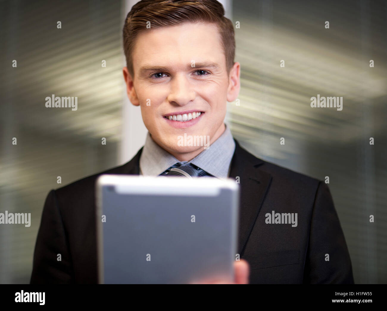 Corporate guy using tablet pc Stock Photo - Alamy