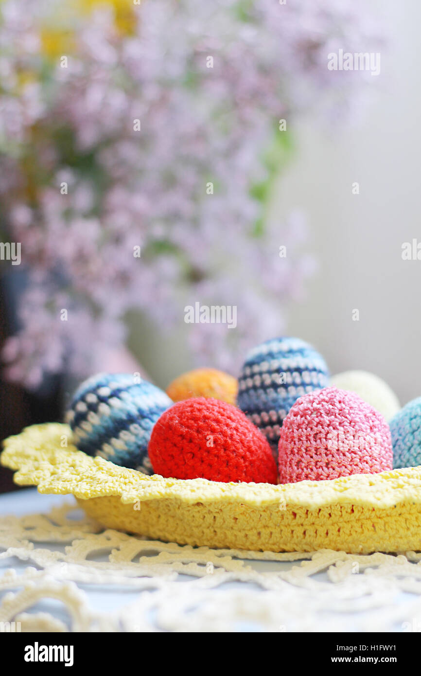 Handmade knitted Easter eggs and lilac flower Stock Photo - Alamy