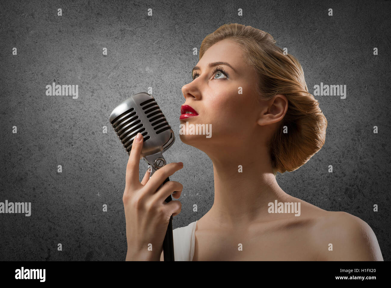 attractive female singer with microphone Stock Photo - Alamy