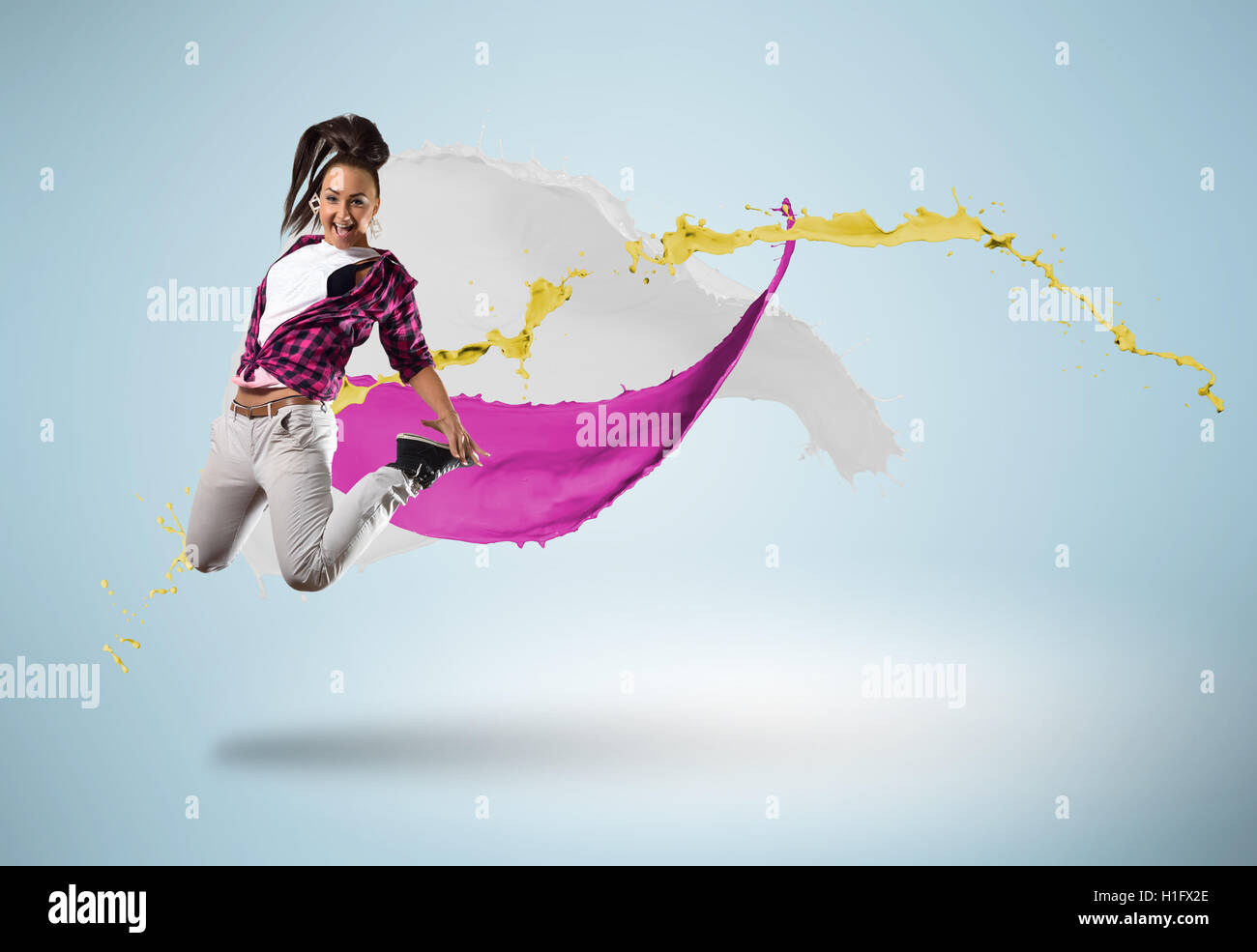 young female dancer jumping with splash of paint Stock Photo - Alamy