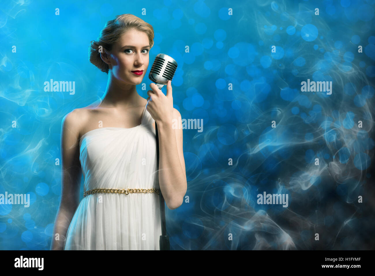 attractive female singer with microphone Stock Photo - Alamy