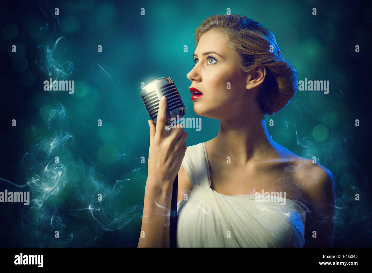 attractive female singer with microphone Stock Photo - Alamy