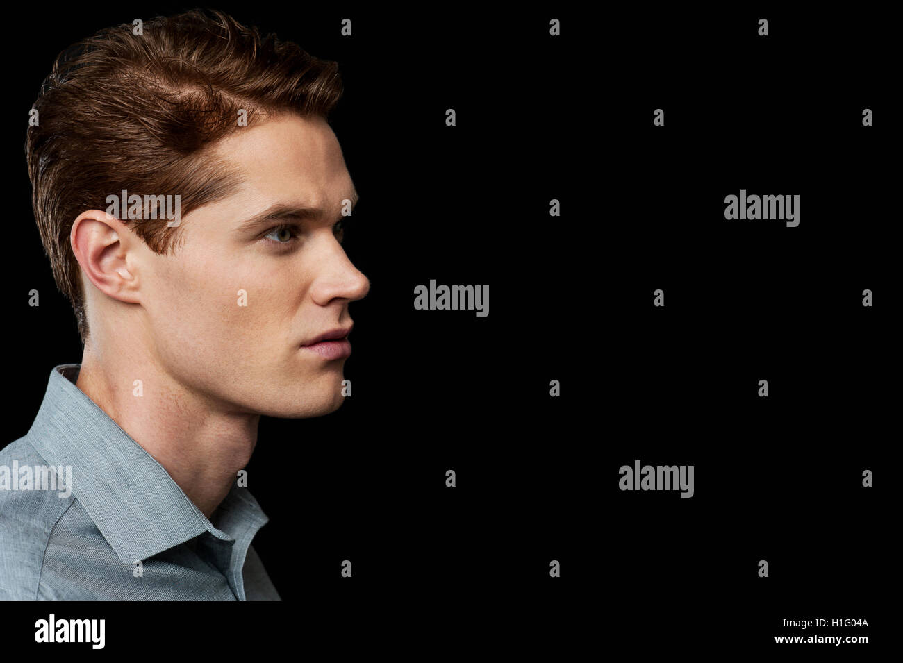 Side pose of stylish young man Stock Photo - Alamy