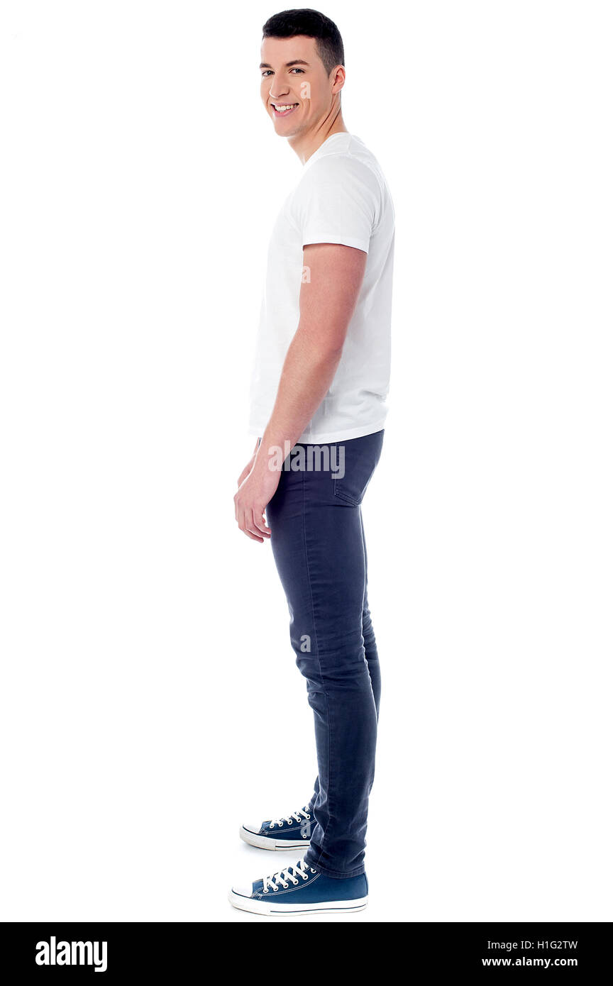 Side pose image of young smart guy Stock Photo - Alamy