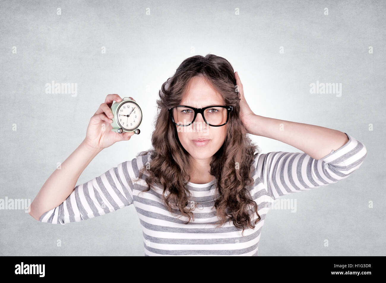 Female with clock Stock Photo - Alamy