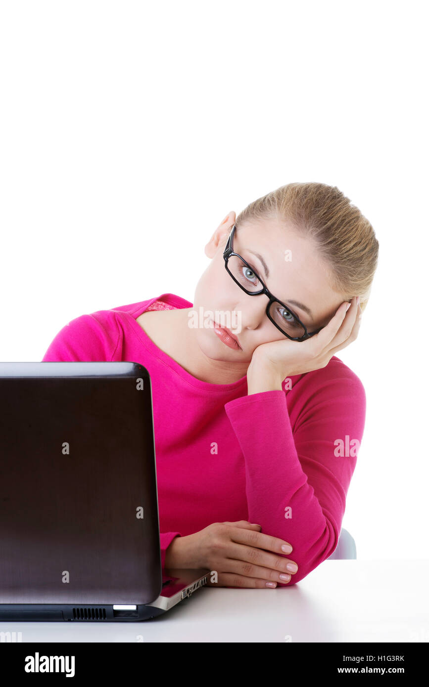 Bored, sad woman sitting in front of laptop Stock Photo - Alamy