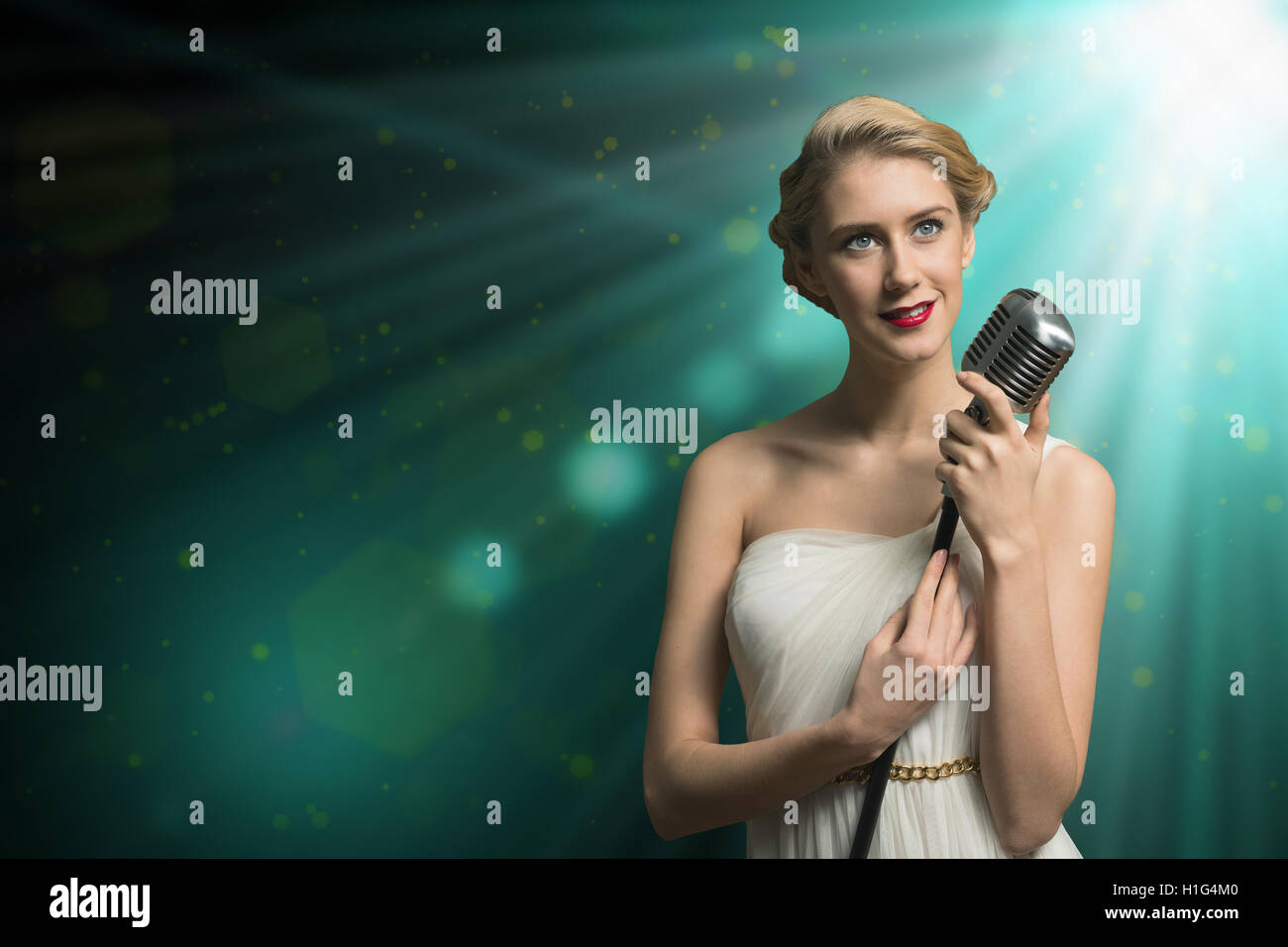 attractive female singer with microphone Stock Photo - Alamy