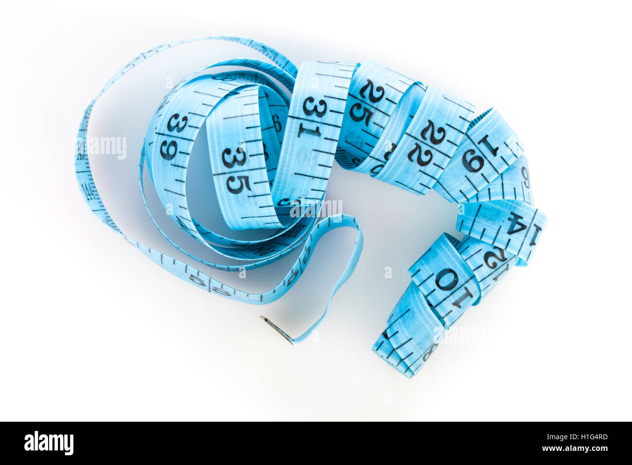 Blue measuring tape, shot from above, on white Stock Photo - Alamy