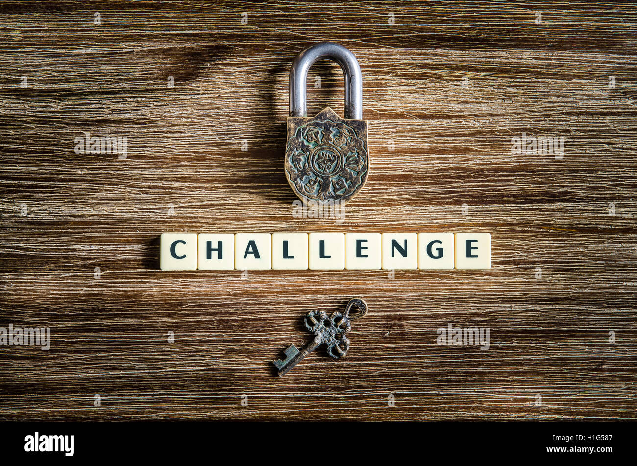 Old vintage padlock and key with challenge sign Stock Photo - Alamy