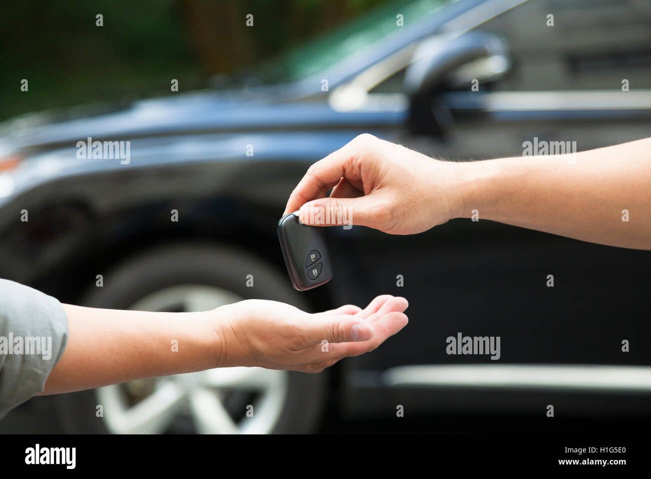 hands giving and receiving car key Stock Photo - Alamy