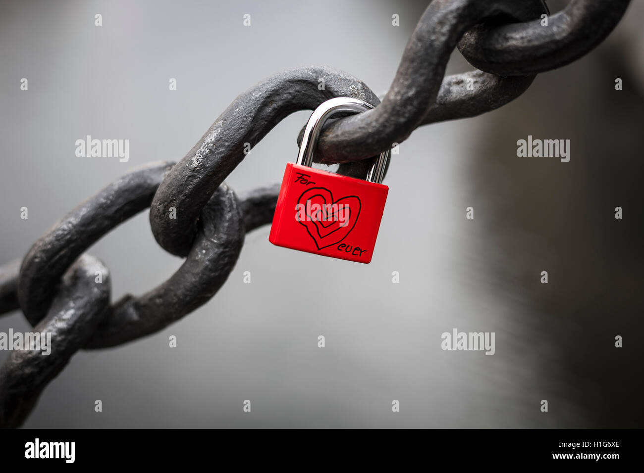 red padlock hanging on a big chain with heart and the words for Stock ...