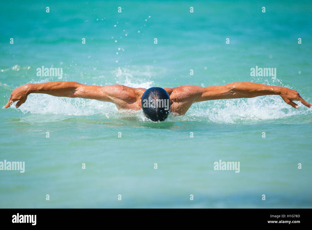 young man swimming in oceans water Stock Photo - Alamy