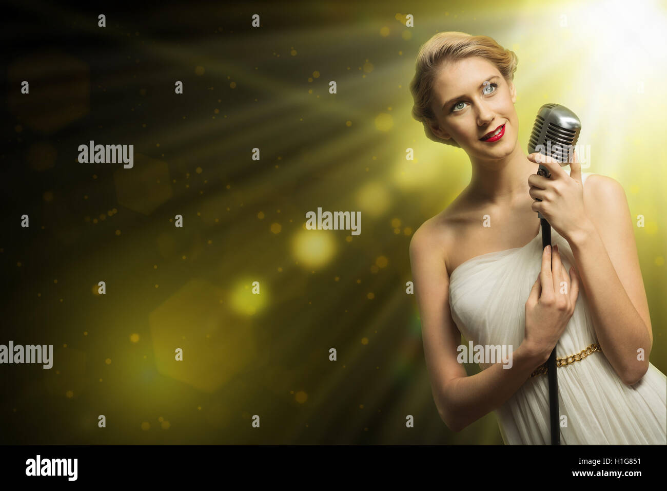 attractive female singer with microphone Stock Photo - Alamy