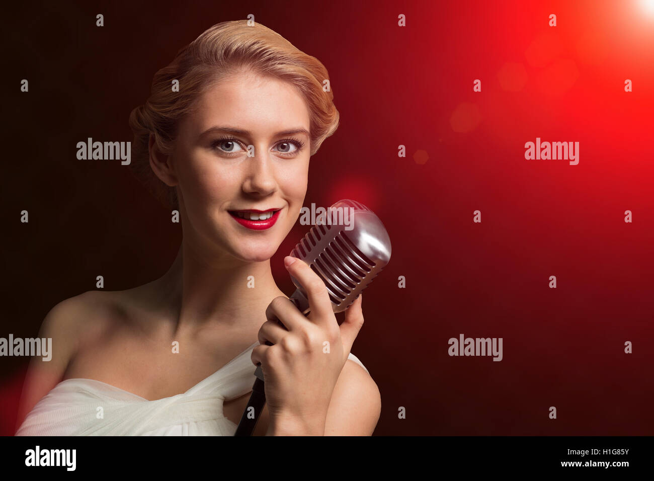 attractive female singer with microphone Stock Photo - Alamy