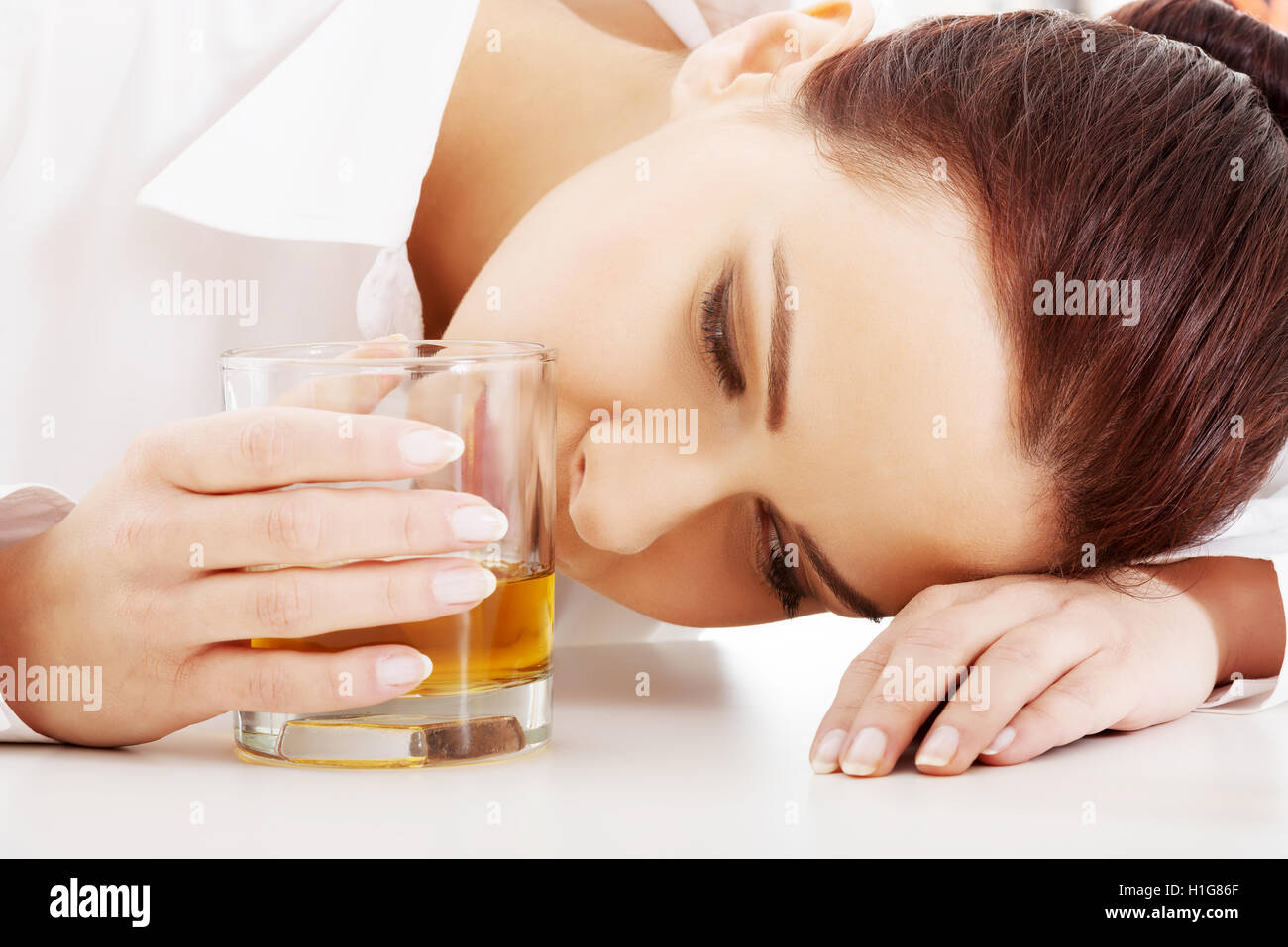 Young beautiful business woman with glass of whisky or rum Stock Photo - Alamy