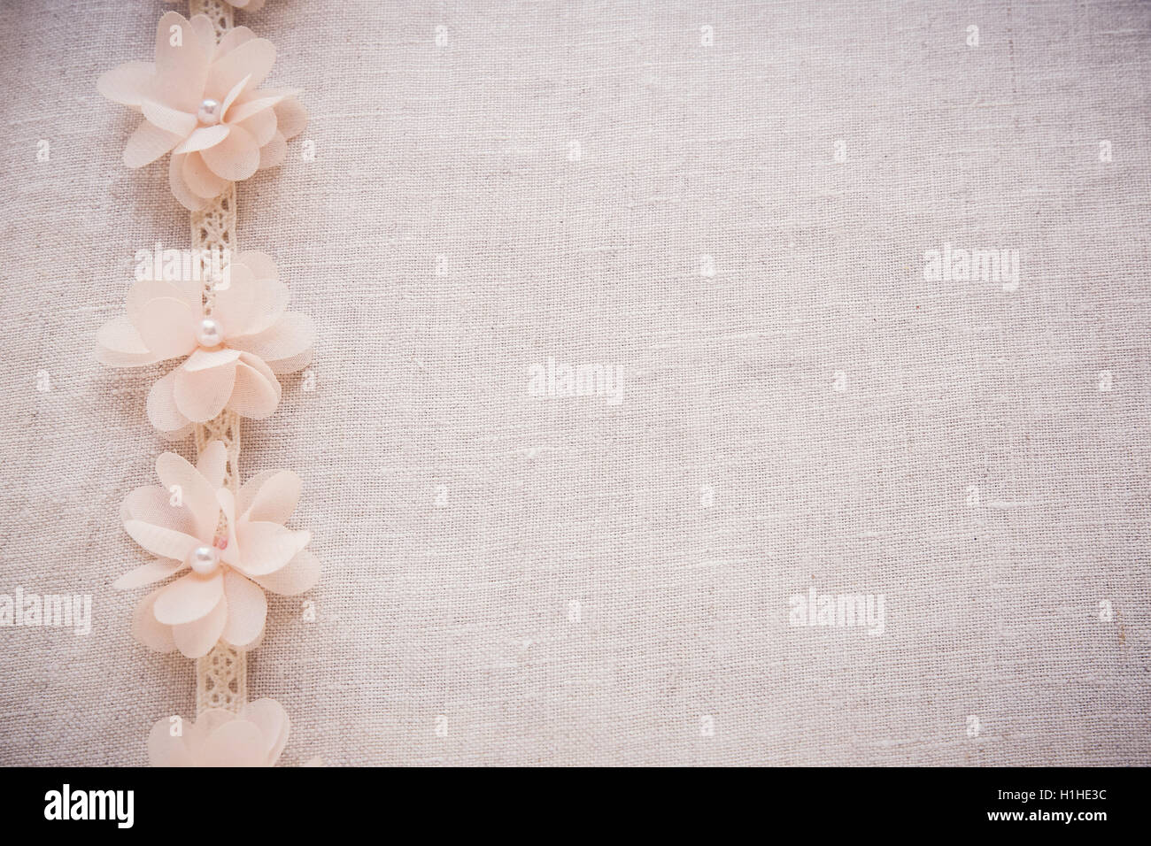 Flowers and lace on linen, copy space toning vintage wedding background ...