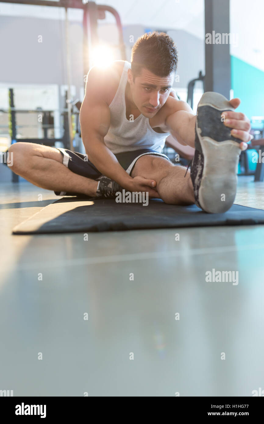 Male fitness model doing sit ups and crunches exercising abdominal ...