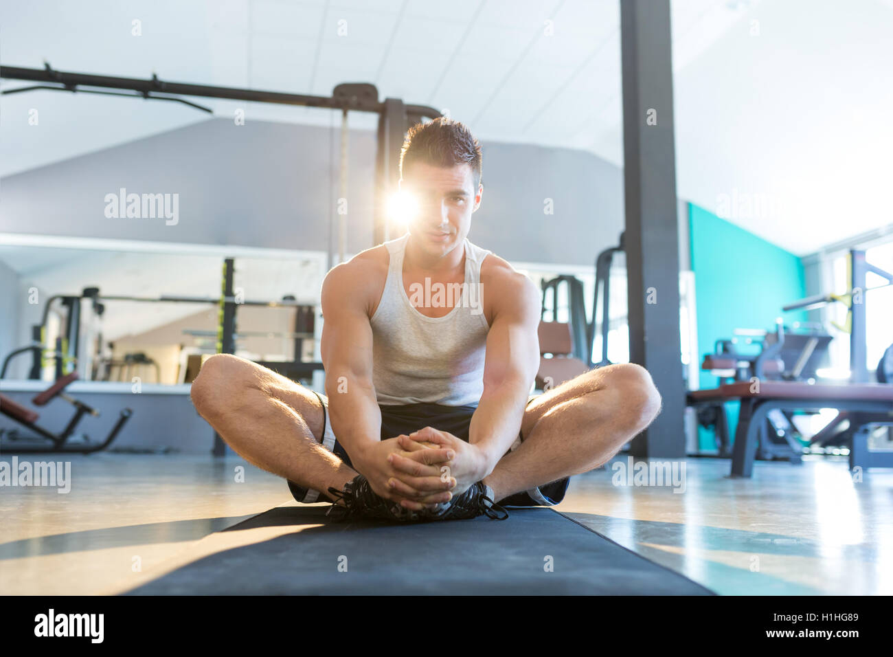 Male fitness model doing sit ups and crunches exercising abdominal ...