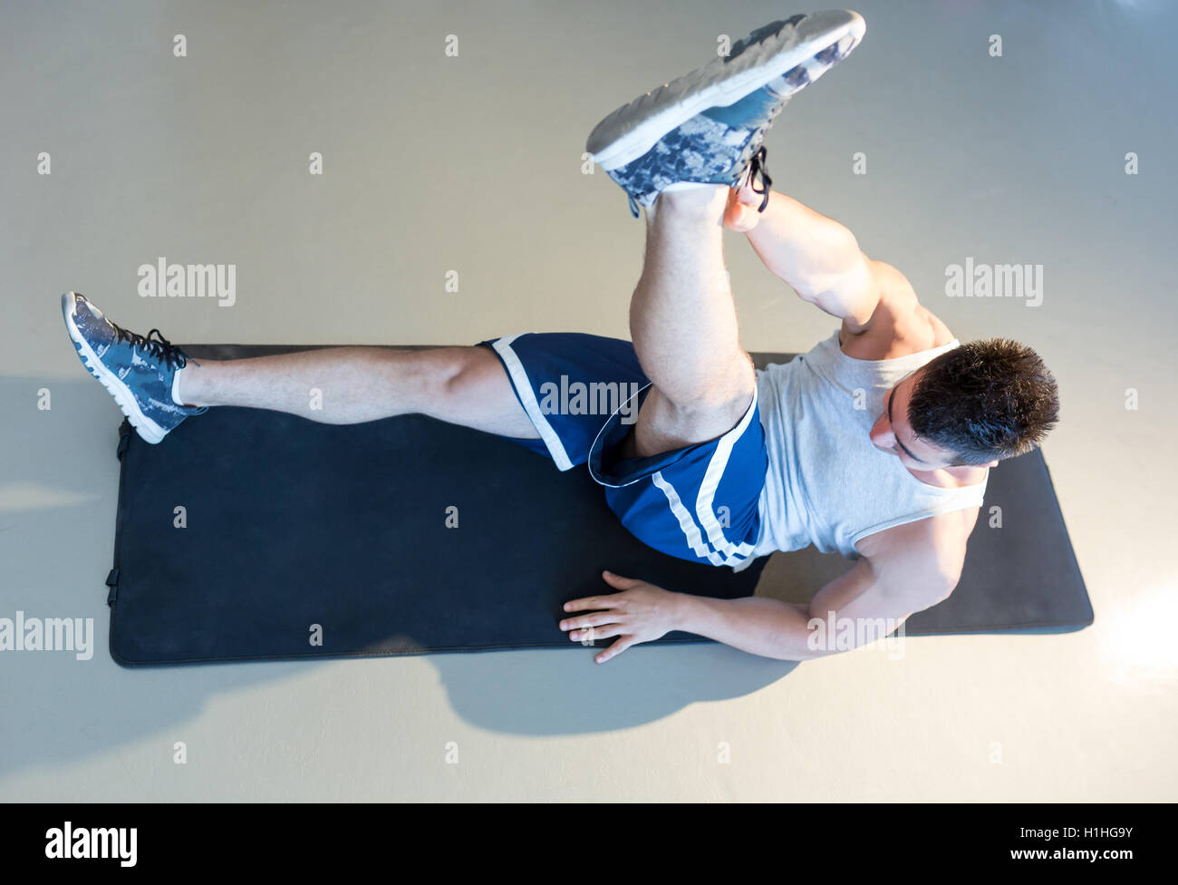Male fitness model doing sit ups and crunches exercising abdominal ...