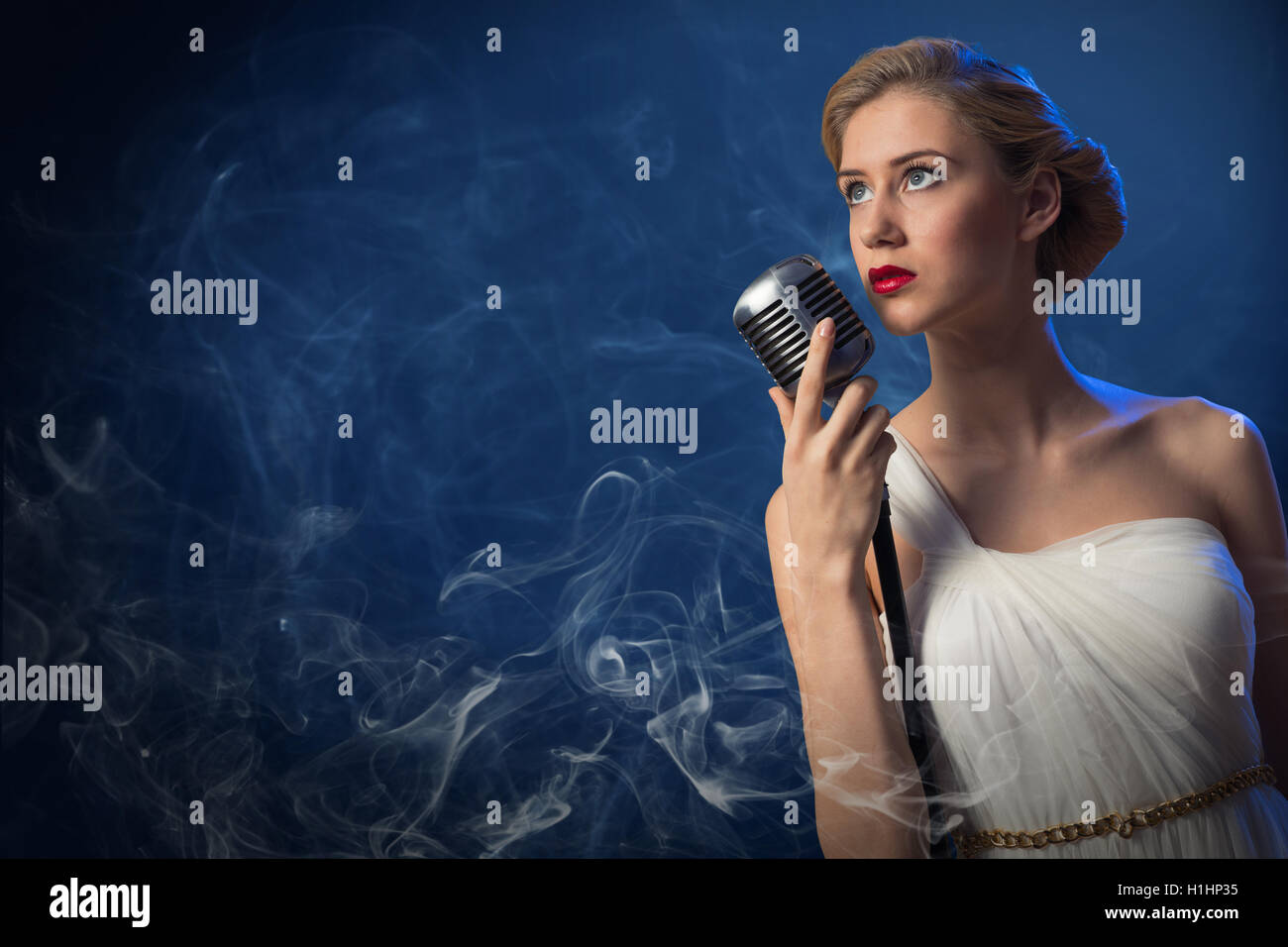 attractive female singer with microphone Stock Photo - Alamy