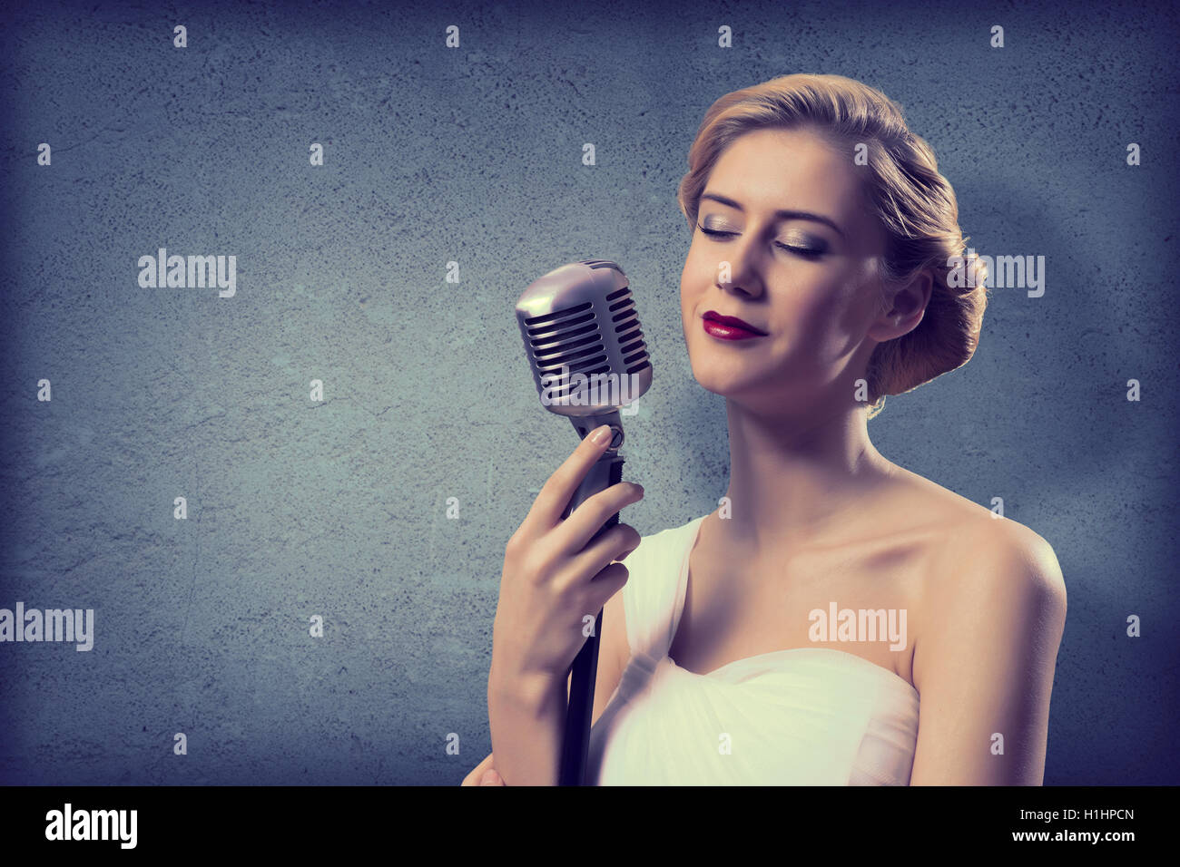 attractive female singer with microphone Stock Photo - Alamy