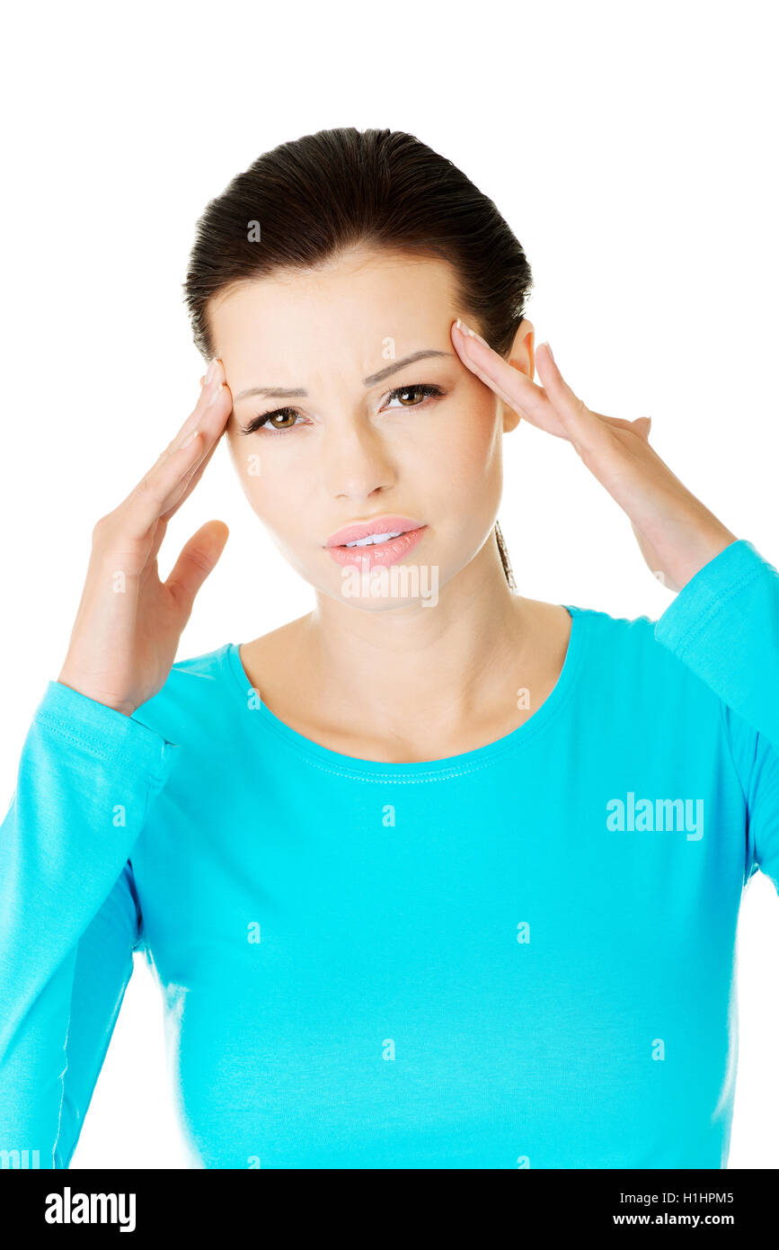 Beautiful casual woman is touching her temples Stock Photo - Alamy